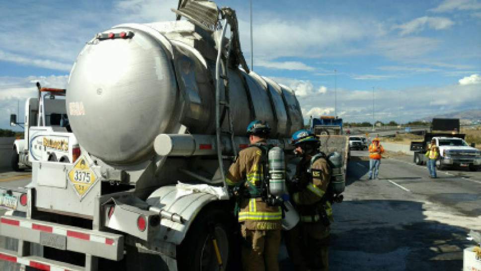 Semitanker rig hauling hazardous material topples on I-15, snarling ...